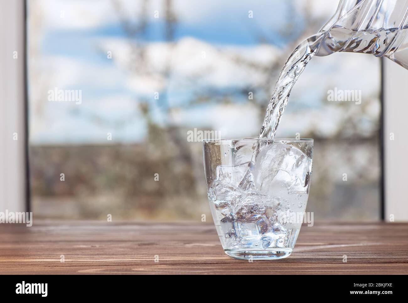 water pouring from jug into glass Stock Photo - Alamy