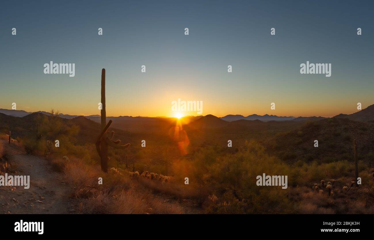 The sun rising above the Arizona Desert with the Four Peaks in the ...