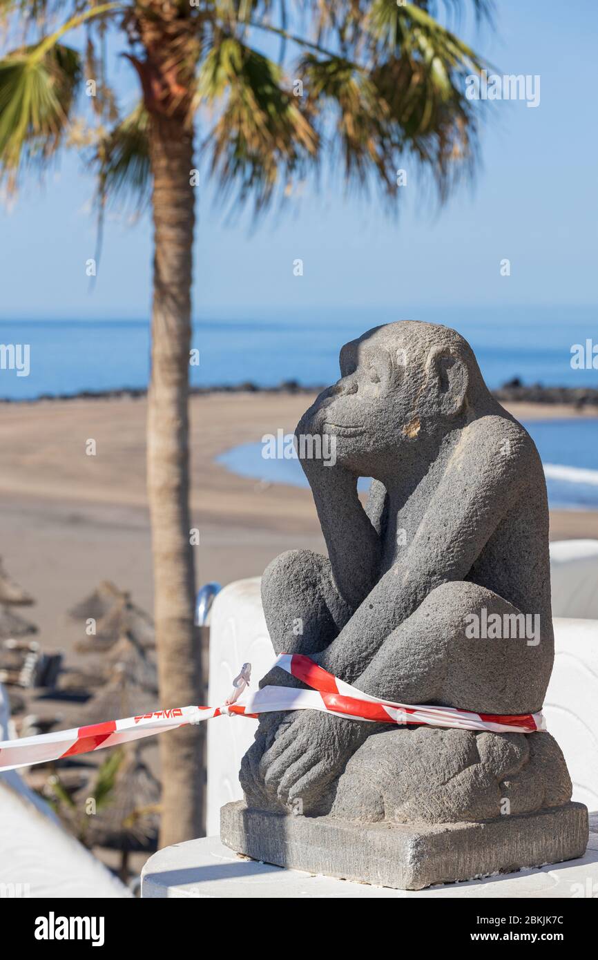 Tape closing access to the Playa troya tied around a stone monkey ...