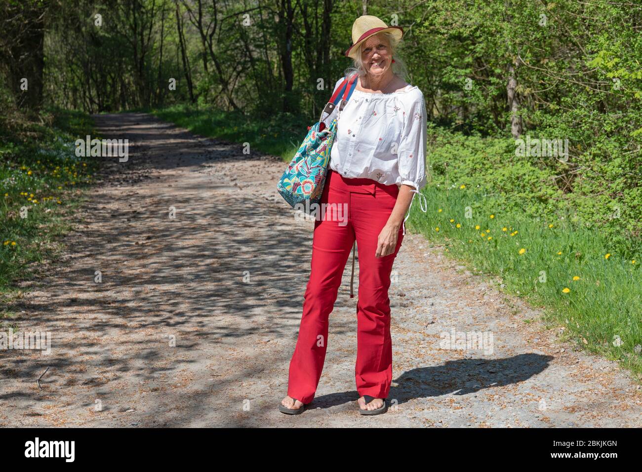Europe, Luxembourg, Insenborn, Attractive older woman walking through ...