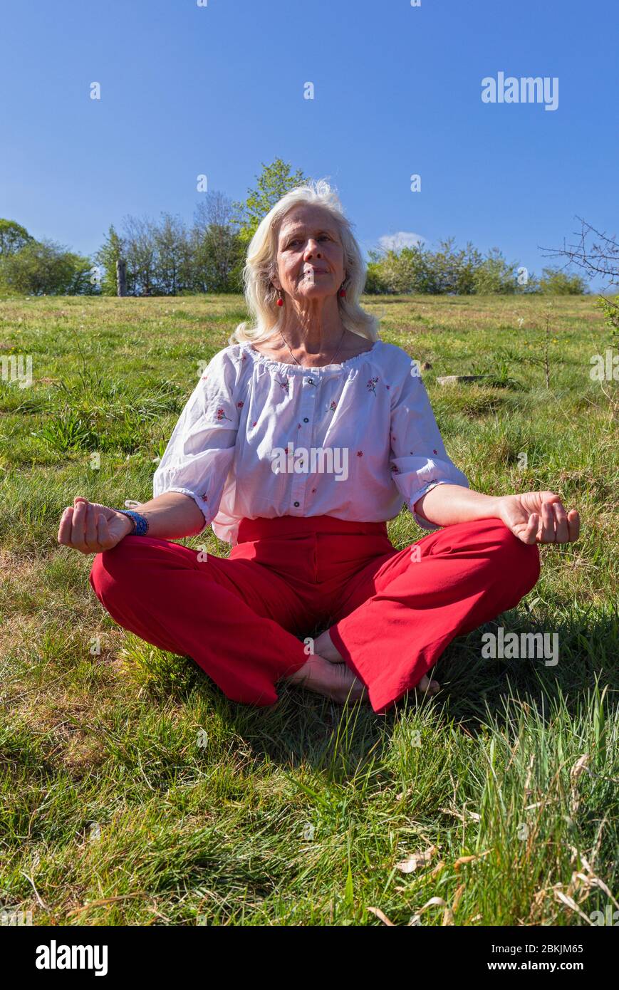 Europe, Luxembourg, Insenborn, Attractive older woman meditating near ...