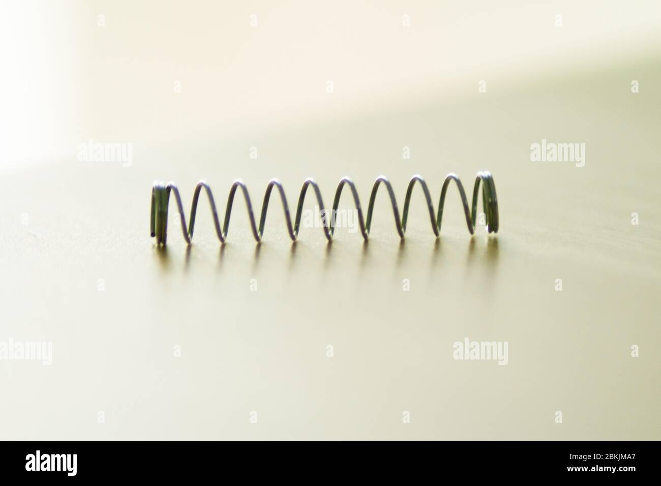 Small wire spring of a ballpoint pen. No people Stock Photo - Alamy