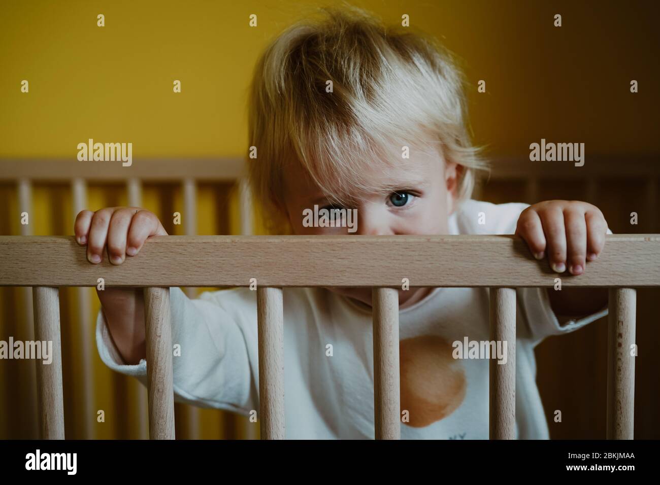 Little boy playing in his cot Stock Photo - Alamy
