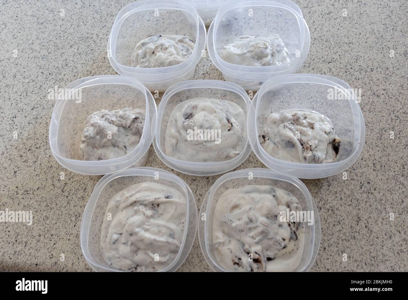 Homemade cookies and cream yogurt put into individual containers on a ...