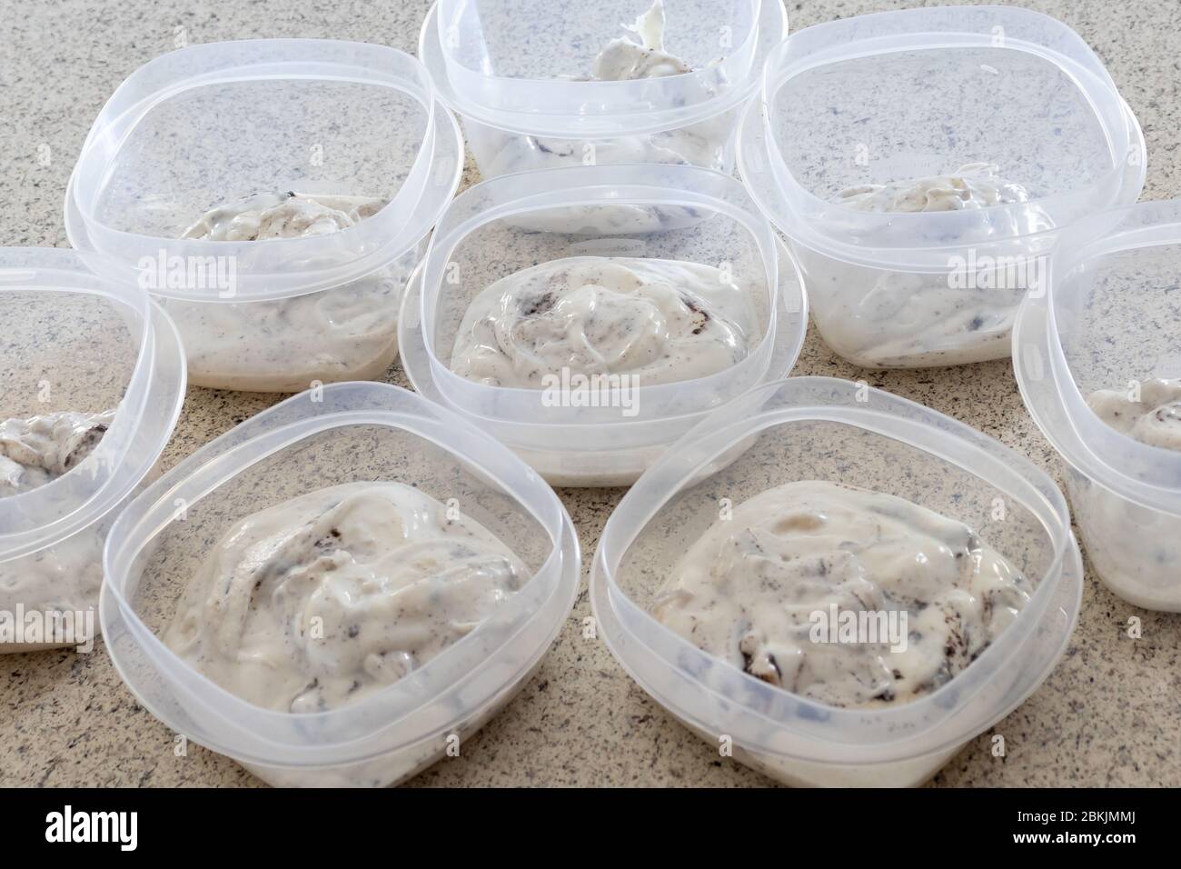 Homemade cookies and cream yogurt put into individual containers on a ...
