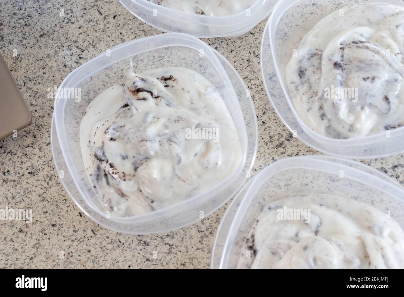 Homemade cookies and cream yogurt put into individual containers on a ...
