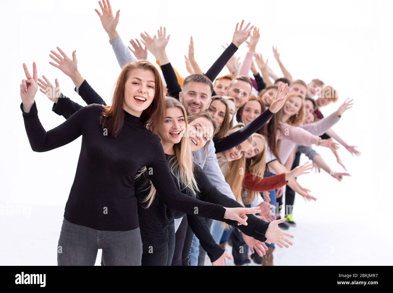 confident guy standing first in the column of young people Stock Photo ...