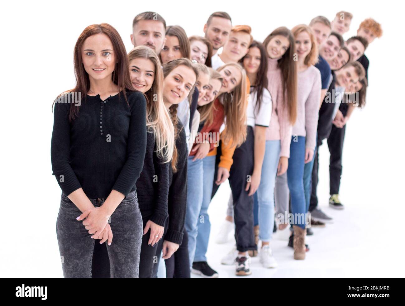 confident guy standing first in the column of young people Stock Photo ...