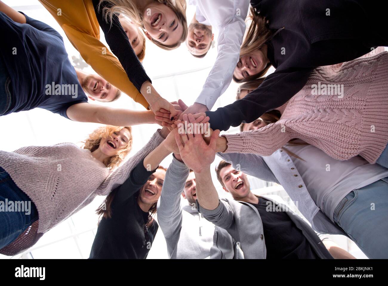 bottom view. a group of young people showing their unity Stock Photo ...