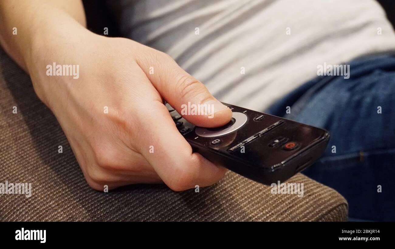 Man switches TV channels. Male hand with TV remote control Stock Photo ...