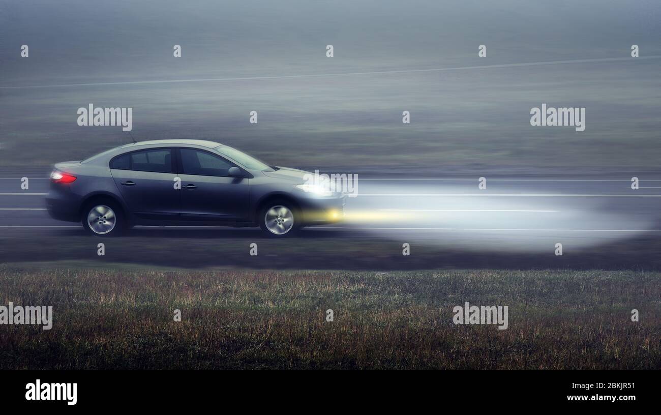 Car on the road in the evening with the dimensions and lights on. Bad ...