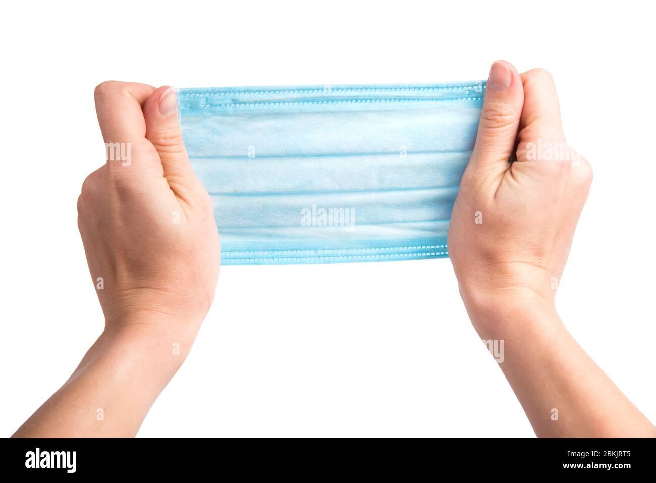 Female hands hold a medical face mask on a white background. Personal ...