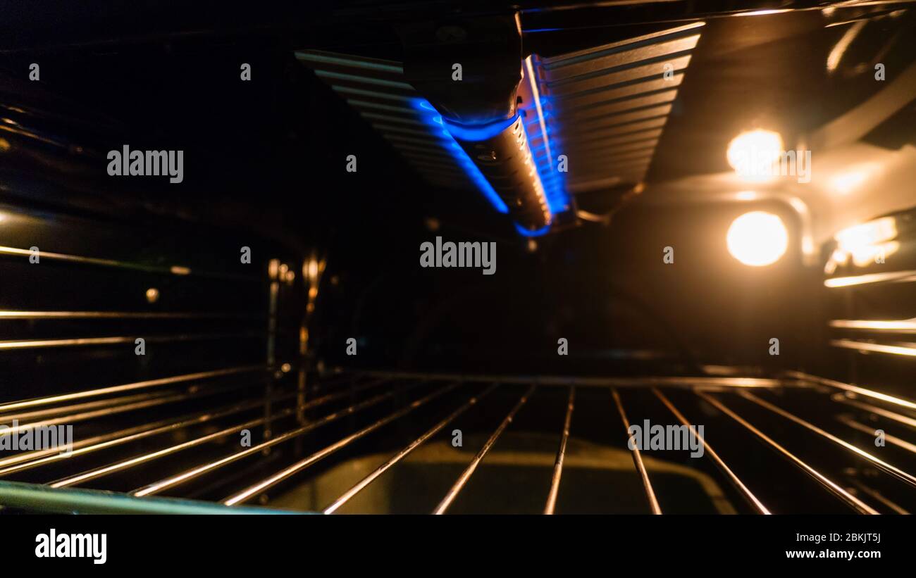 Empty oven inside with blue burning flames Stock Photo - Alamy