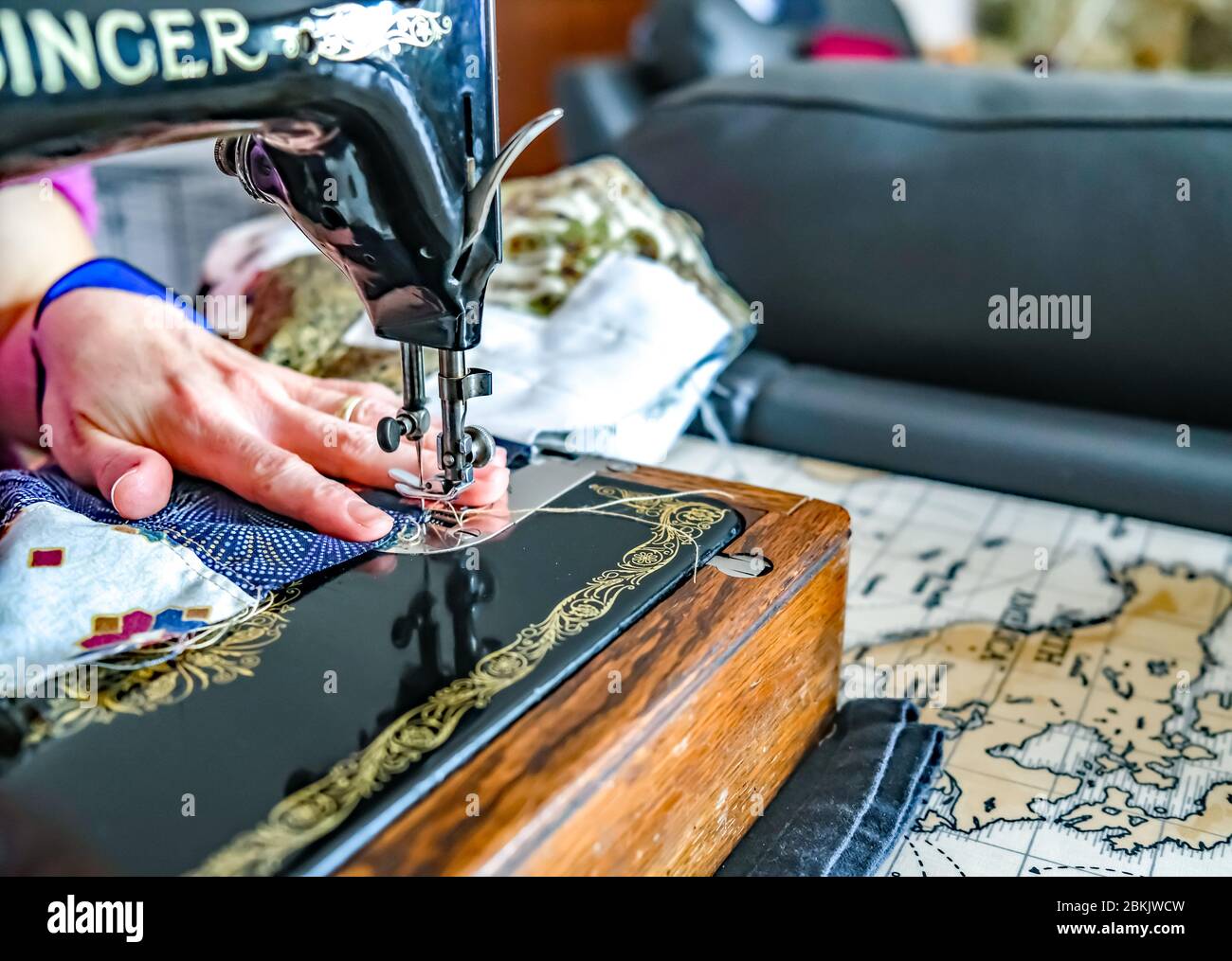 2 Close up of human hand sewing with an old fashioned and traditional ...
