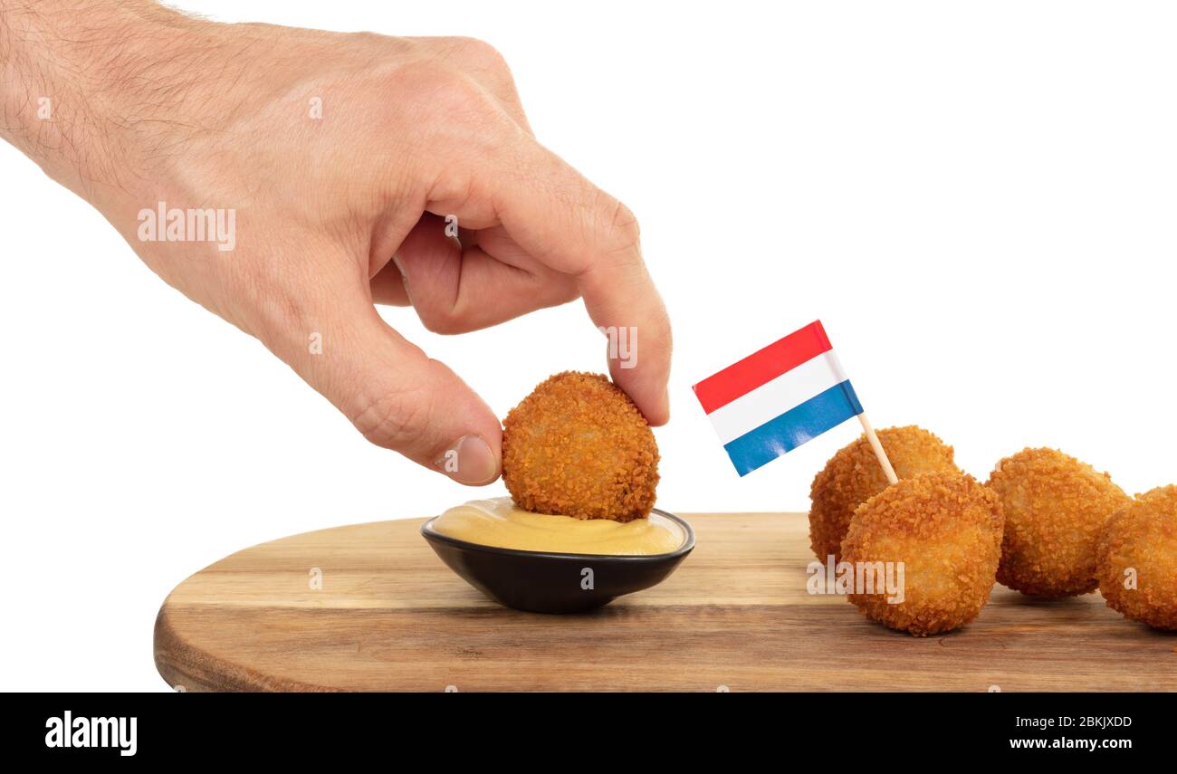 Dutch traditional snack bitterbal in a hand, isolated Stock Photo - Alamy