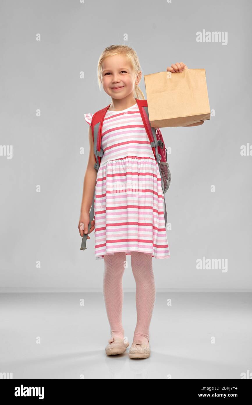 little student girl with school lunch in paper bag Stock Photo - Alamy
