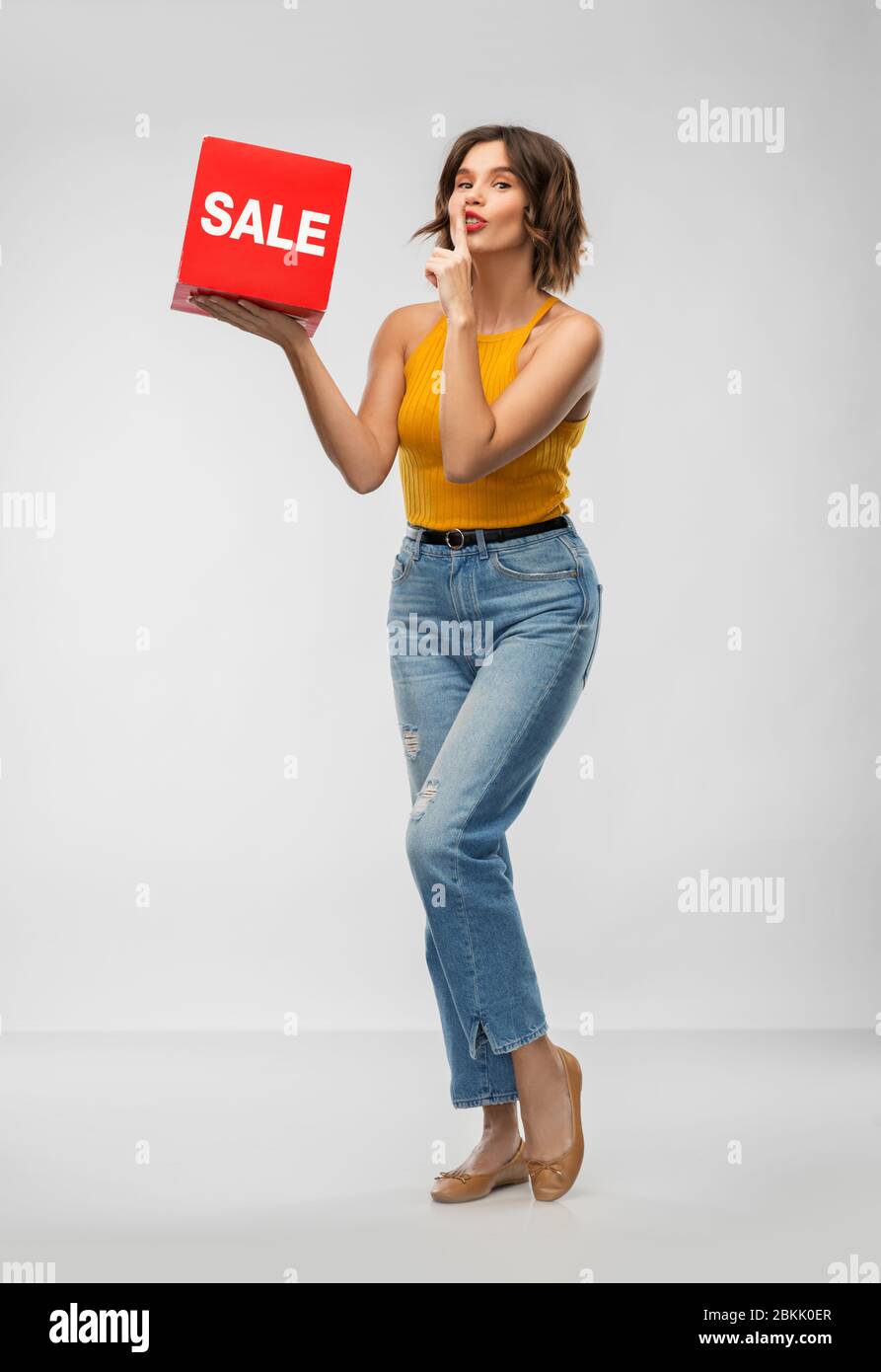 happy smiling young woman posing with sale sign Stock Photo - Alamy