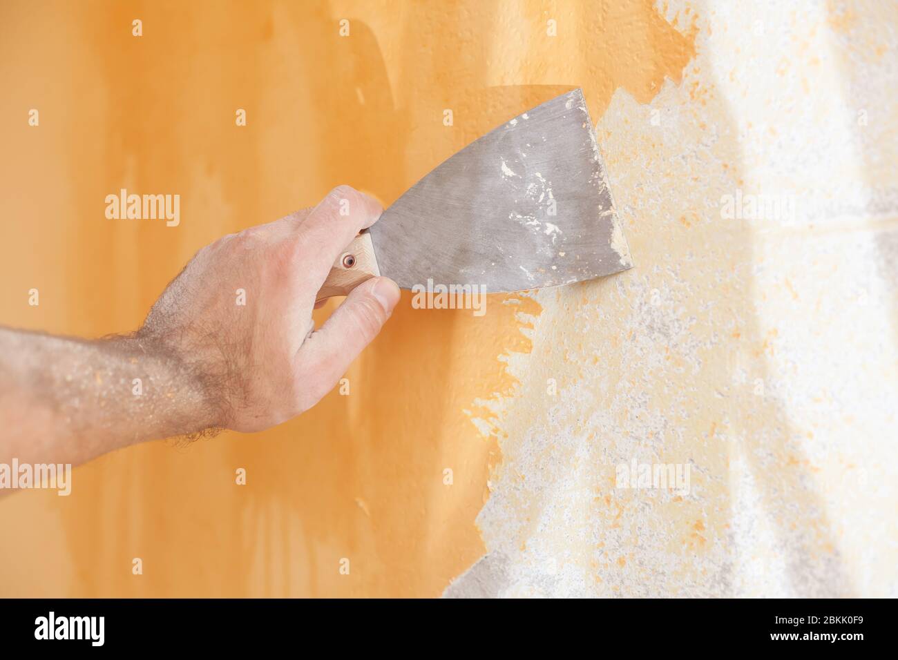 Scraping old plaster and applying new. Reconstruction of a new house ...