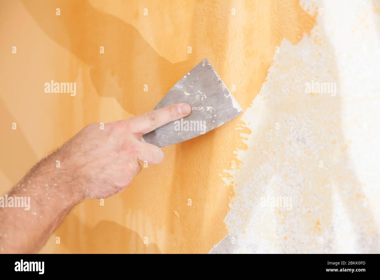 Scraping old plaster and applying new. Reconstruction of a new house ...