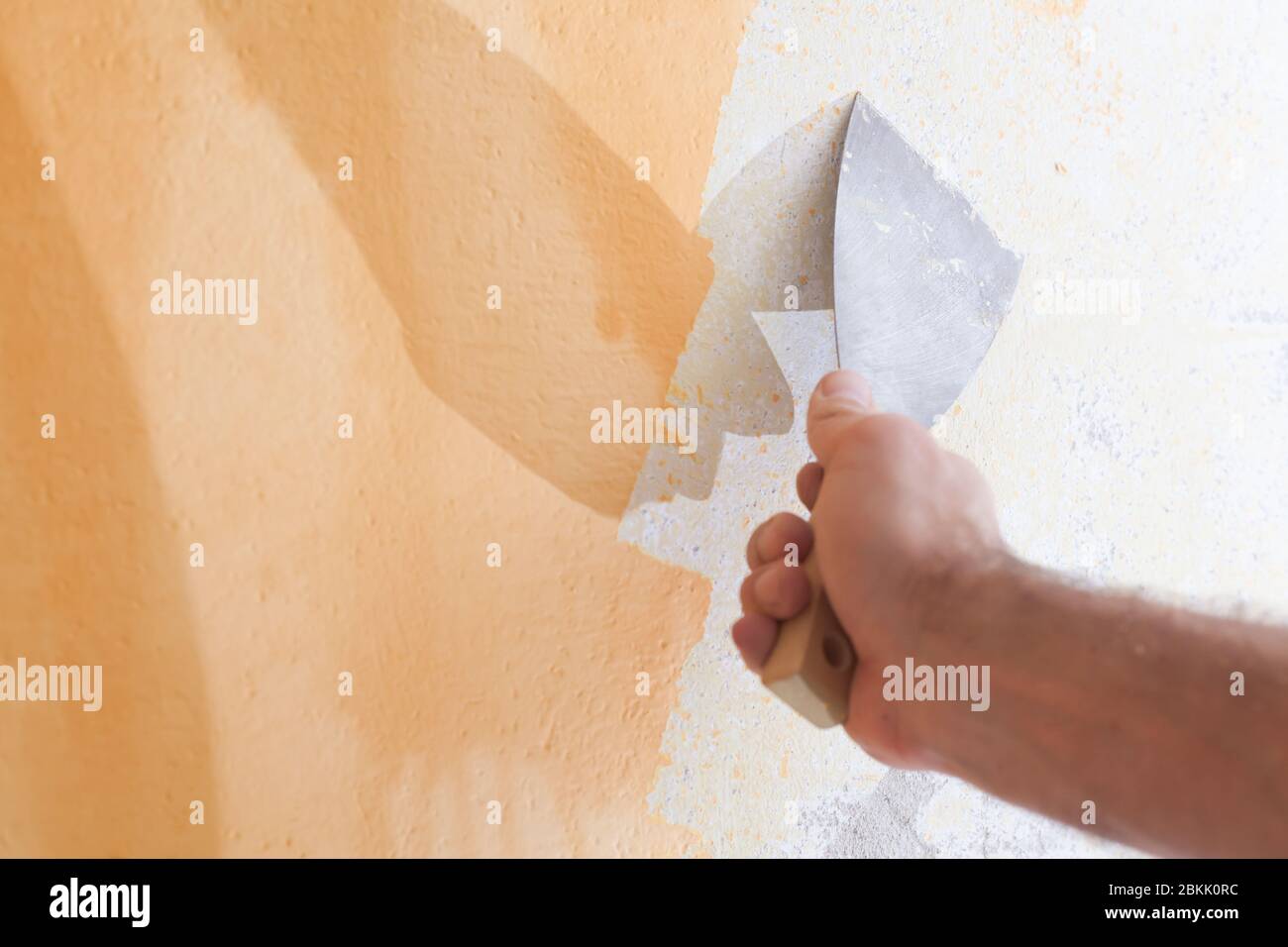 Scraping old plaster and applying new. Reconstruction of a new house ...