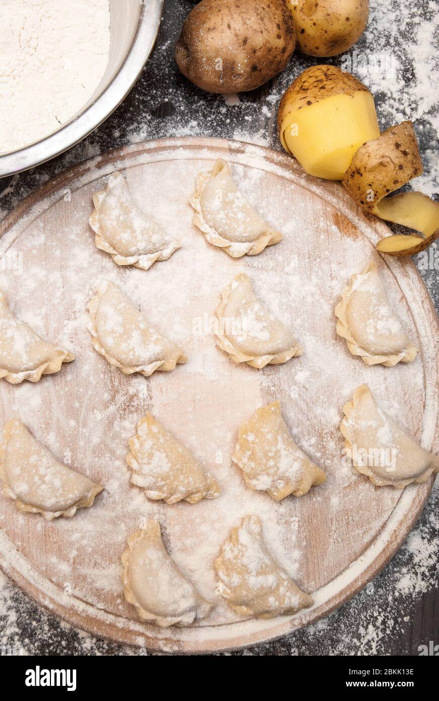 Homemade raw dumplings with filling on a wooden board Stock Photo - Alamy