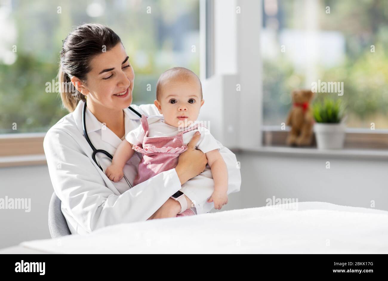 female pediatrician doctor with baby at clinic Stock Photo - Alamy