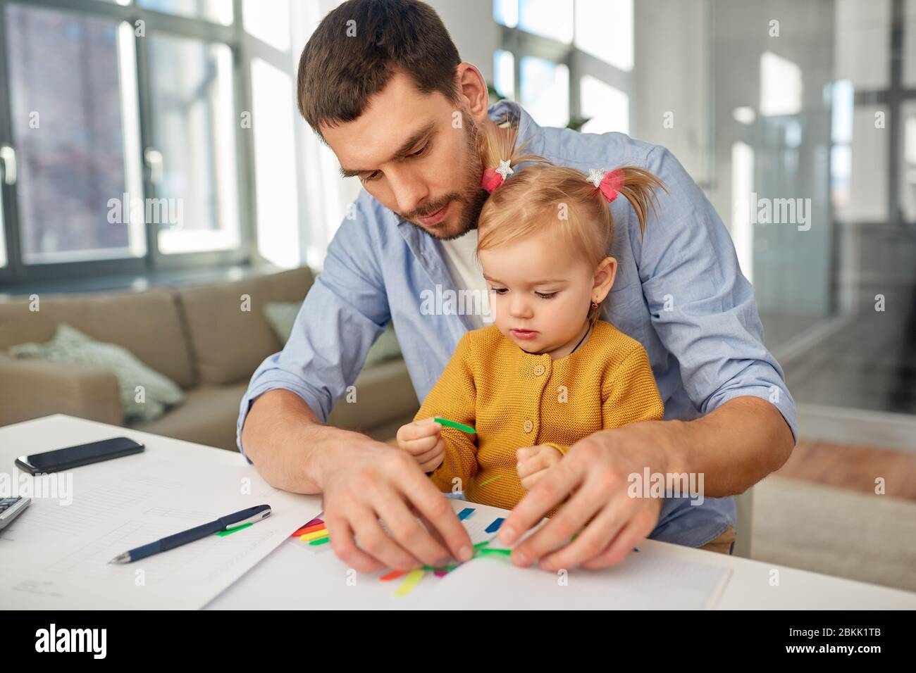 working father with baby daughter at home office Stock Photo - Alamy