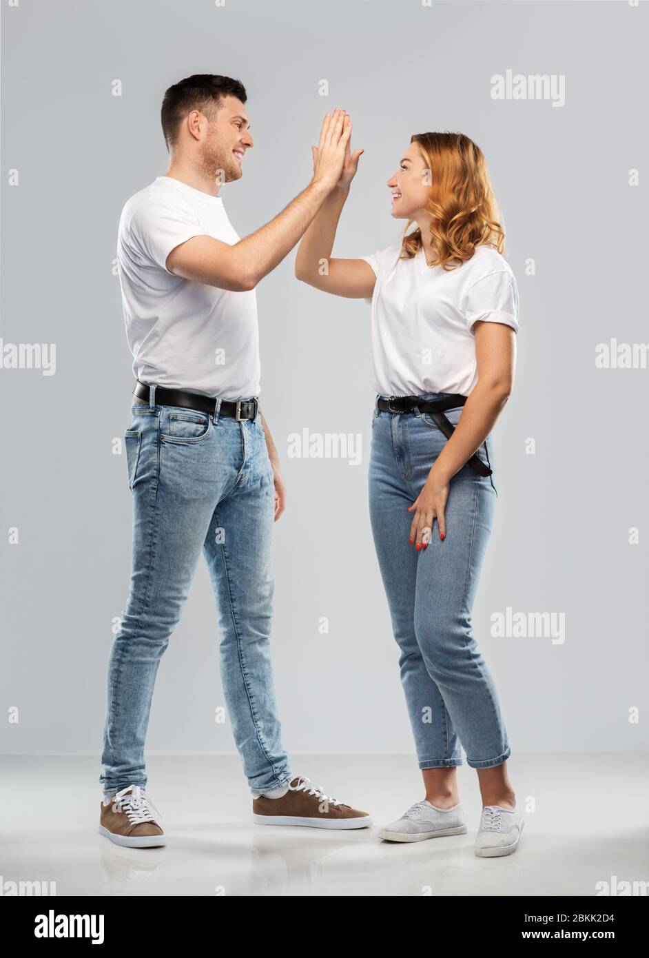 happy couple making high five gesture Stock Photo - Alamy