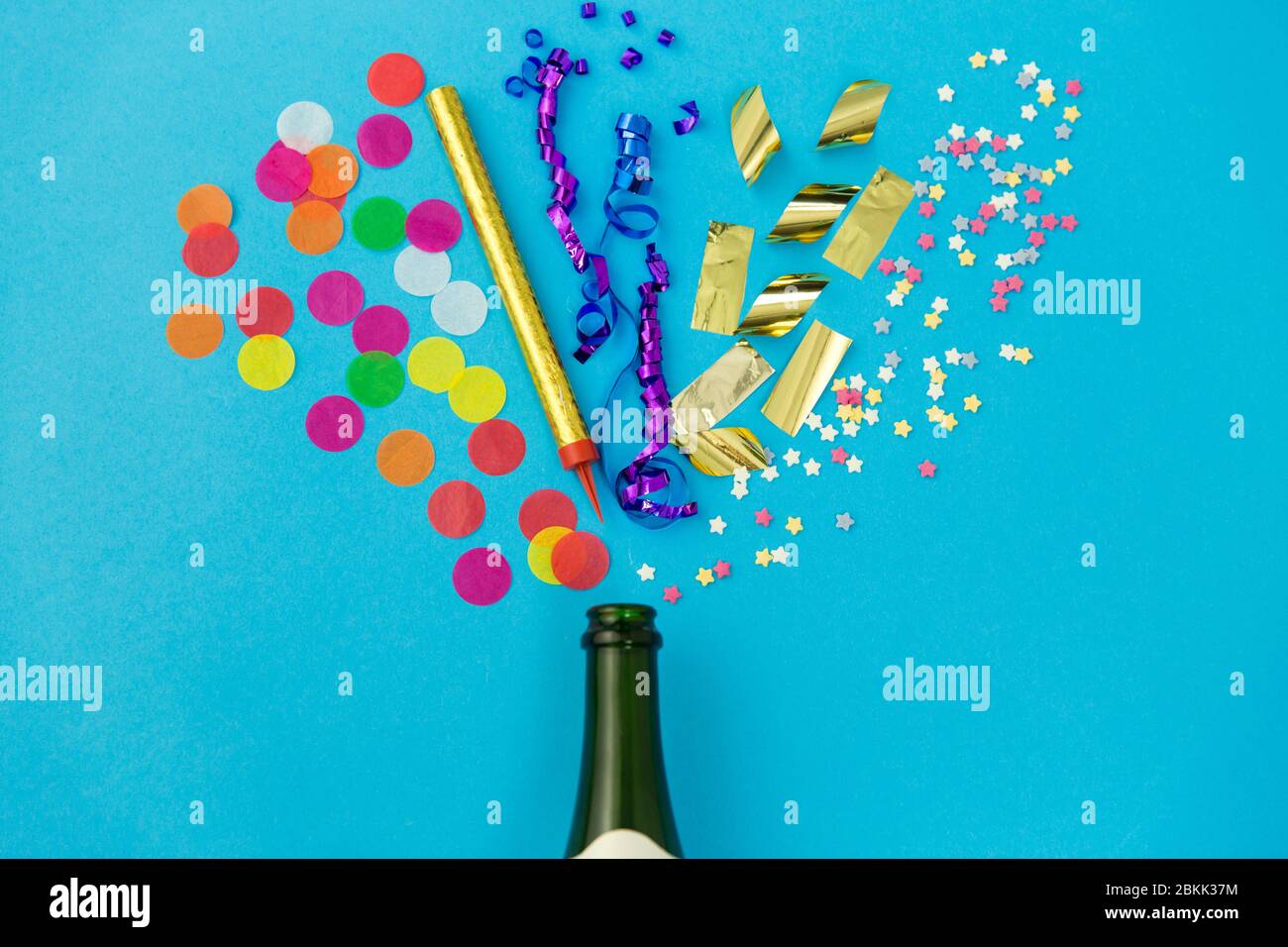champagne bottle with birthday party props on blue Stock Photo - Alamy