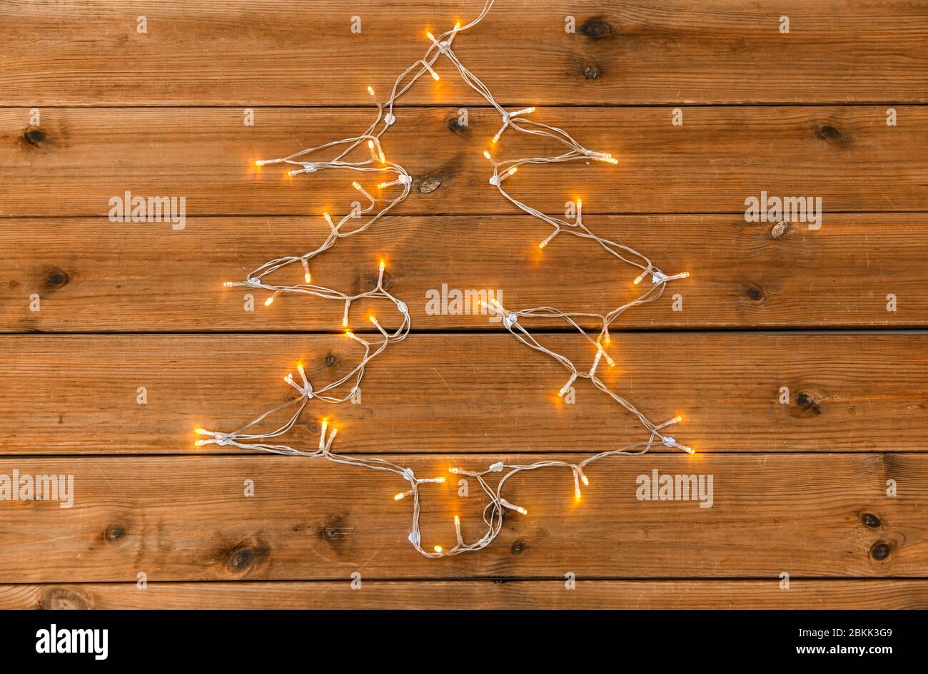 garland lights string in shape of christmas tree Stock Photo - Alamy