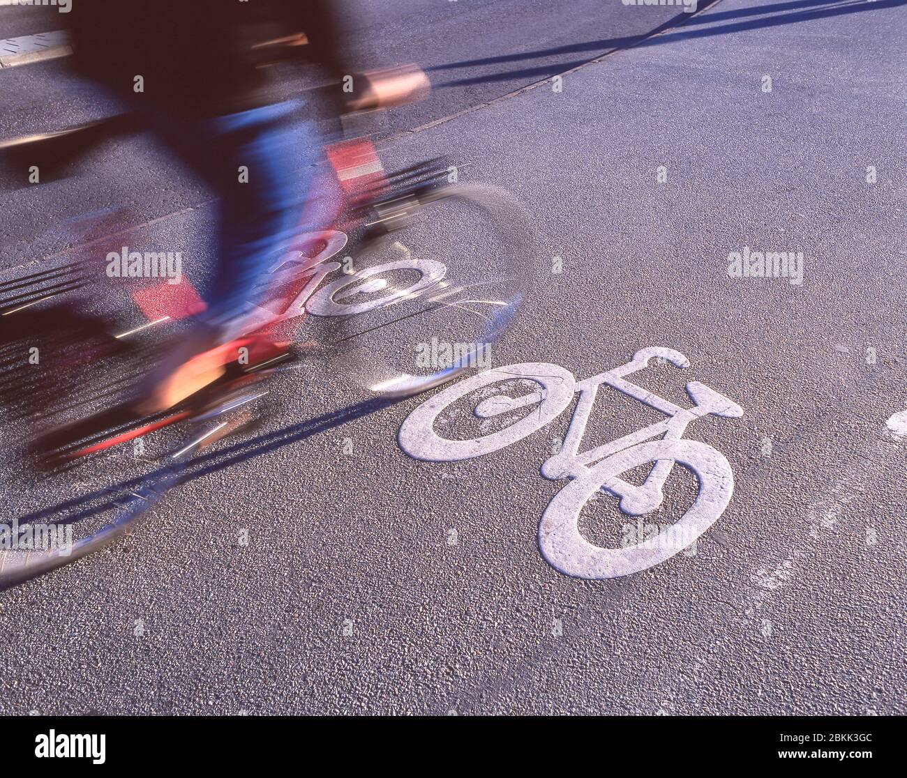 Cyclist using cycle lane, Ashford, Surrey, United Kingdom Stock Photo ...