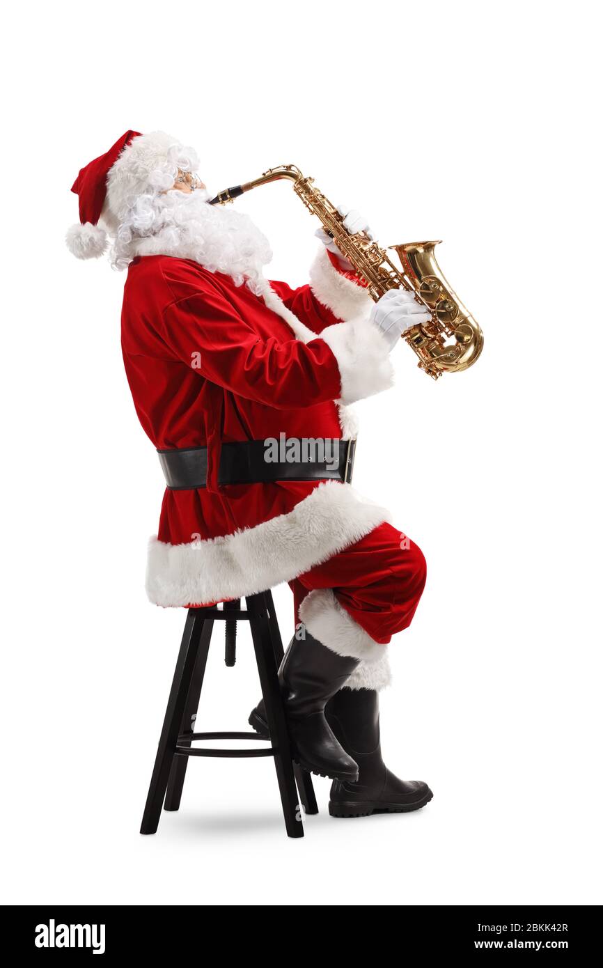 Full length profile shot of Santa Claus sitting and playing a saxophone ...