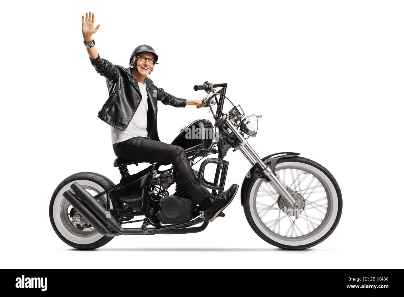 Elderly biker in leather jacket riding a chopper and waving isolated on ...