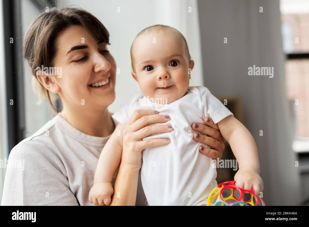 happy young mother holding little baby daughter Stock Photo - Alamy