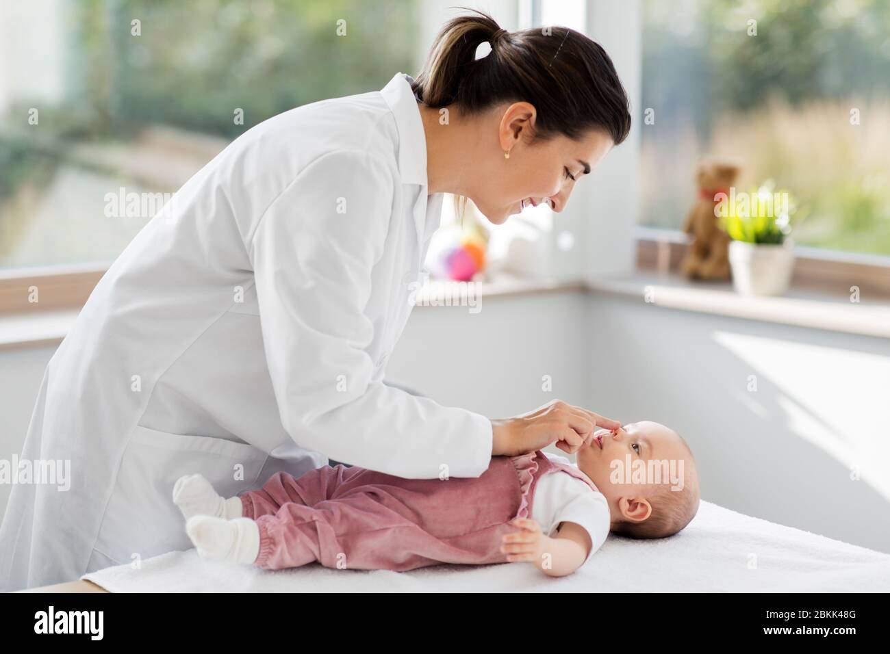 female pediatrician doctor with baby at clinic Stock Photo - Alamy