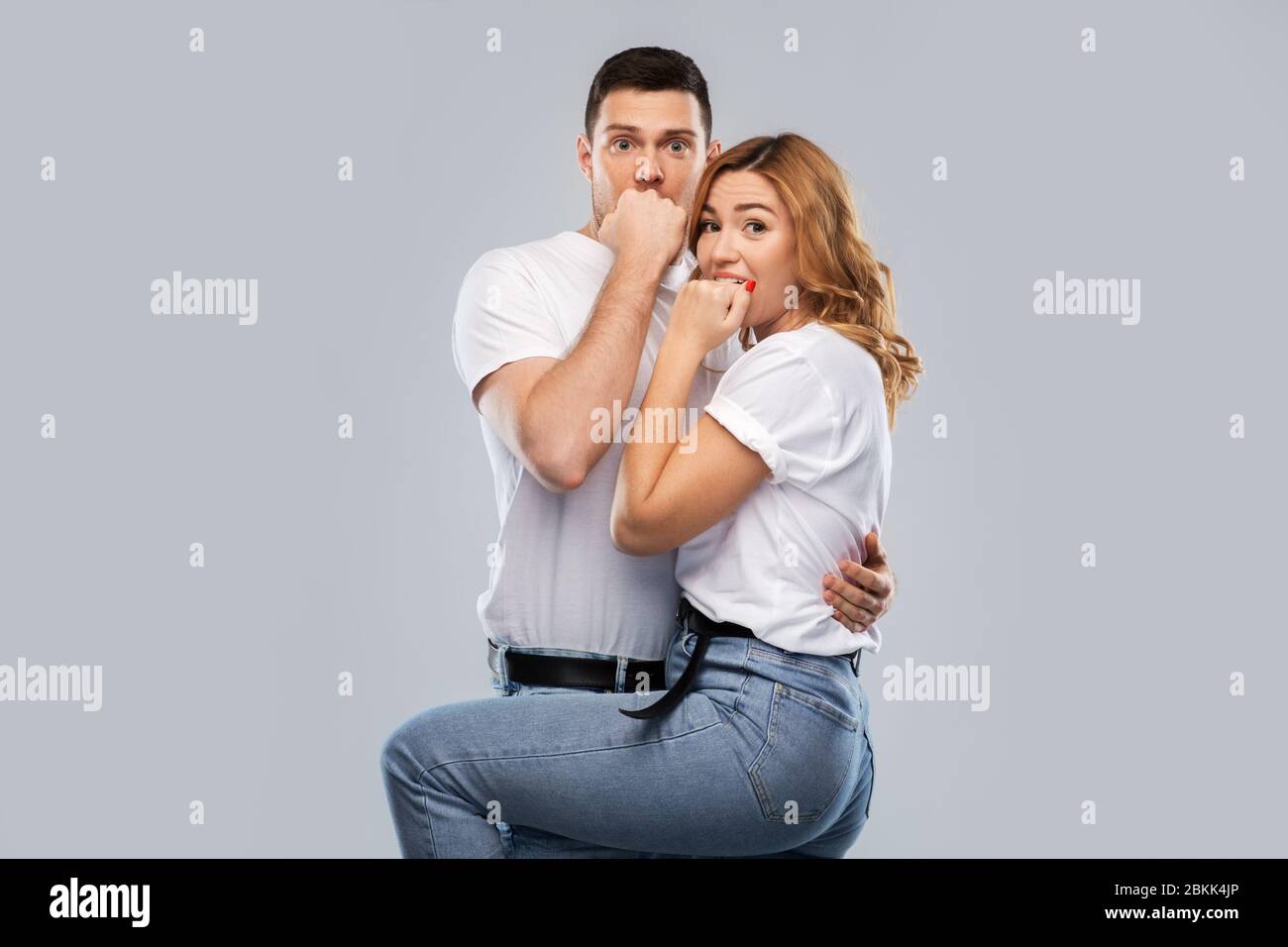scared couple in white t-shirts Stock Photo - Alamy