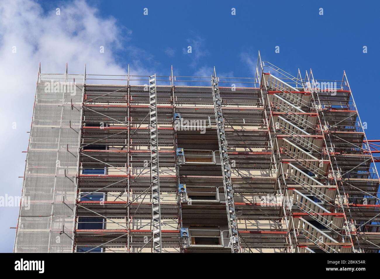 Scaffolding providing platforms for work in progress on a new apartment ...