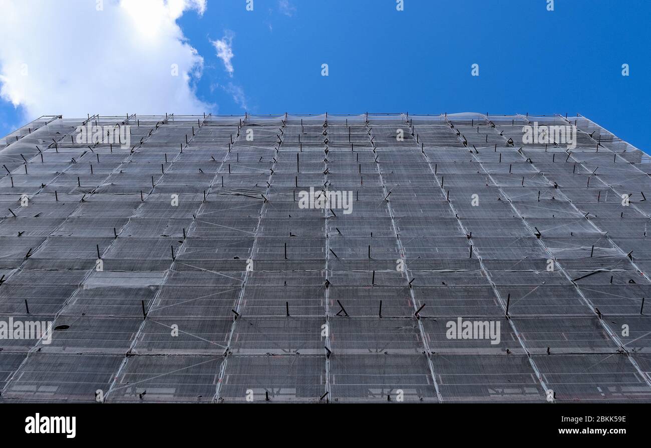 Scaffolding providing platforms for work in progress on a new apartment ...