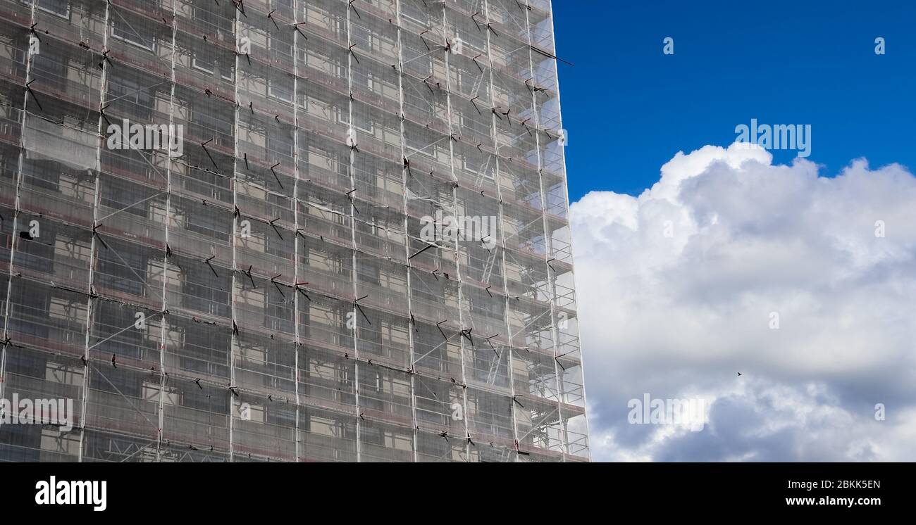 Scaffolding providing platforms for work in progress on a new apartment ...