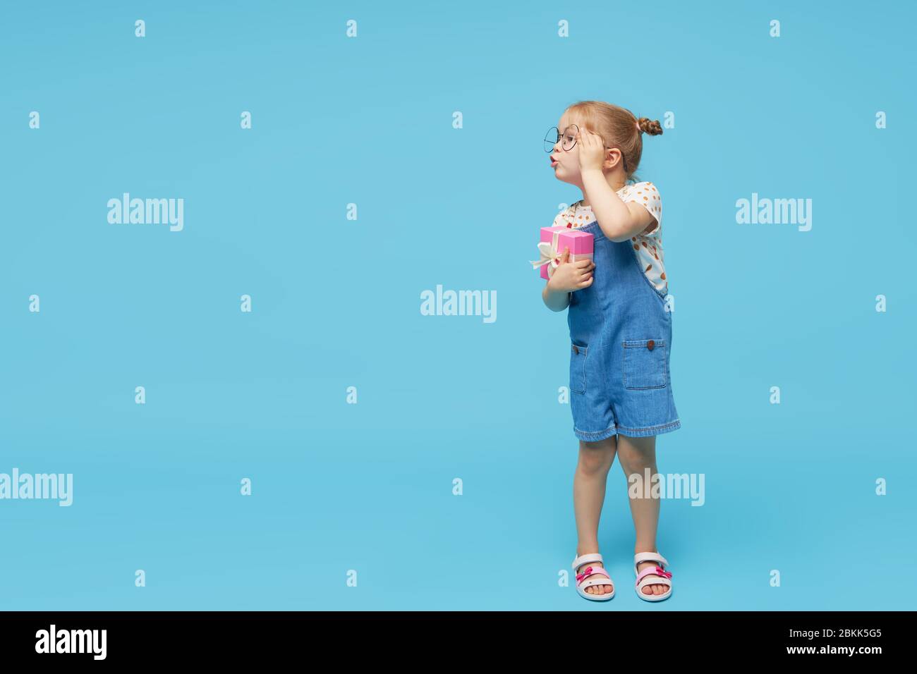 Portrait of surprised cute little toddler girl child standing isolated ...