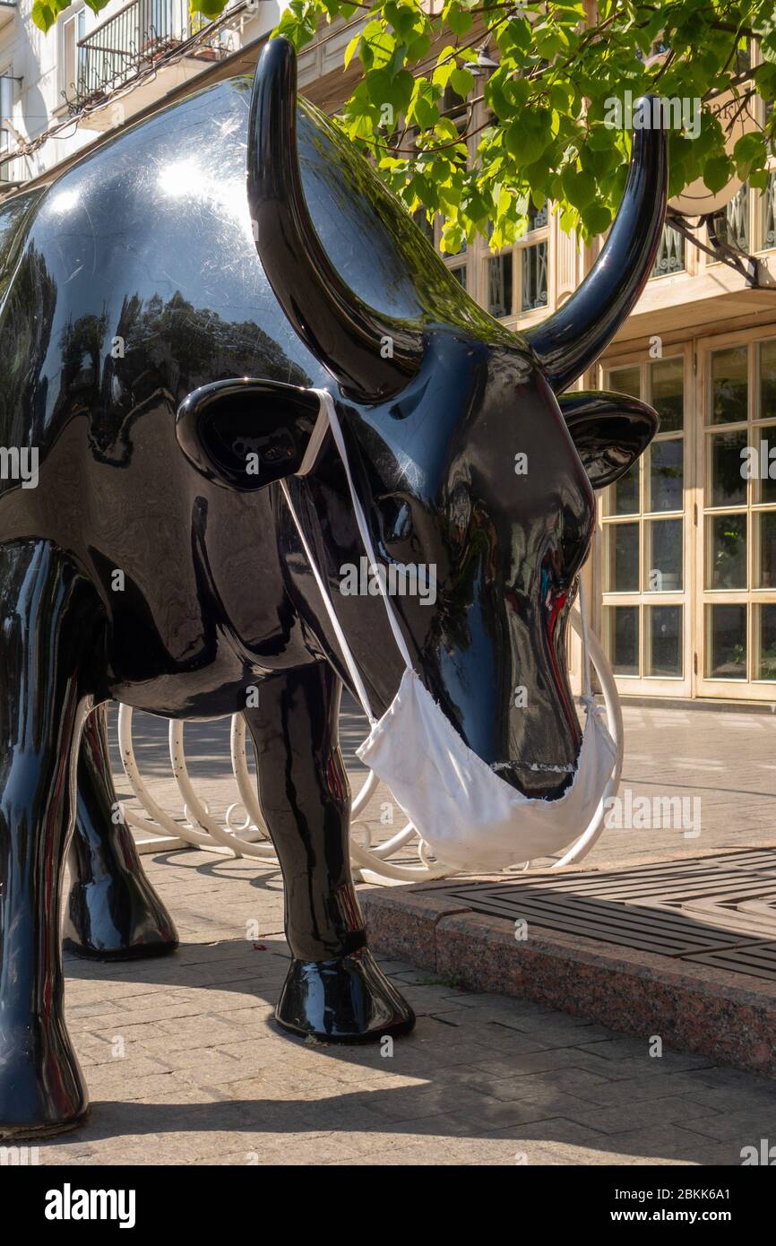 Sham black cow in a surgical mask. City life during a pandemic Stock ...
