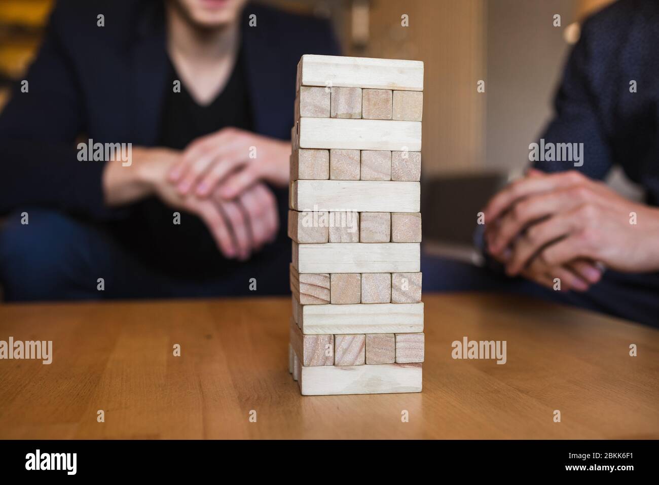 Guys play jenga in a stylish loft cafe with a modern design Stock Photo ...