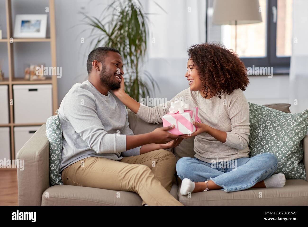 happy couple with gift at home Stock Photo - Alamy