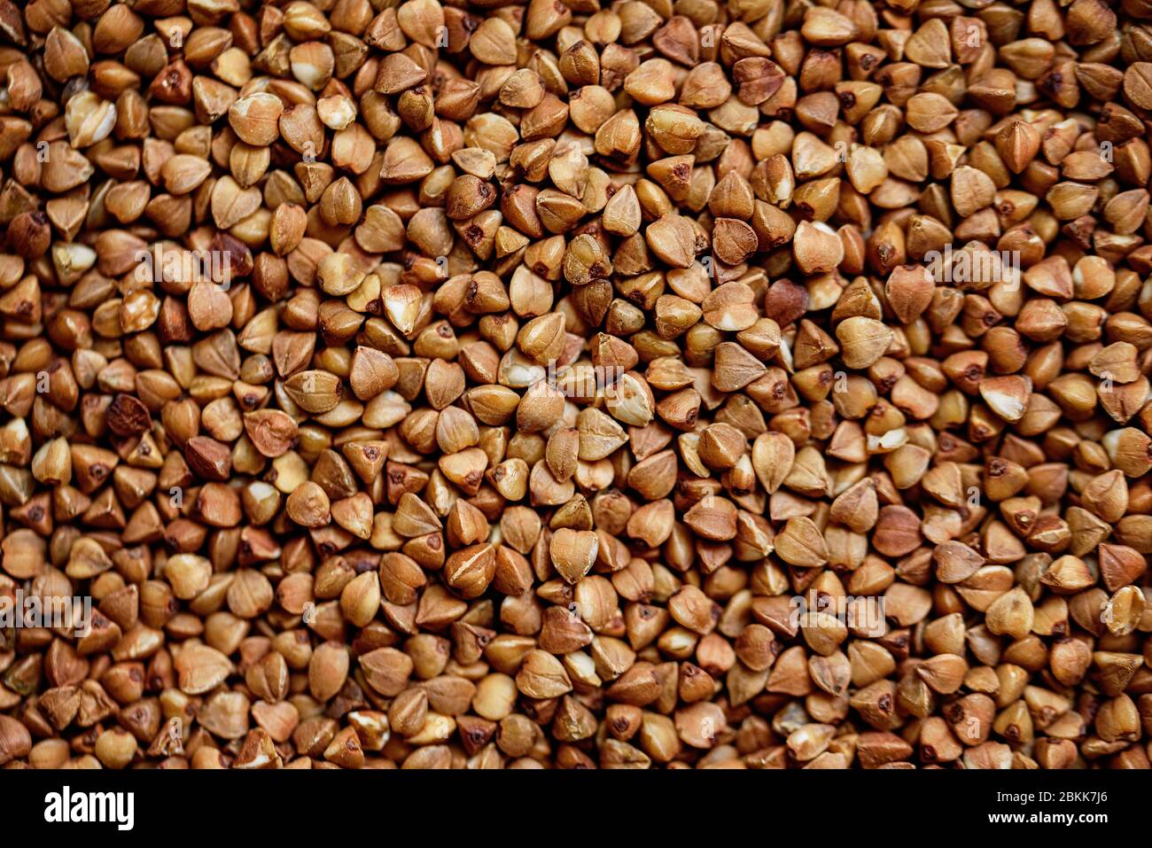 Organic uncooked Scattered buckwheat grain texture background. Healthy ...