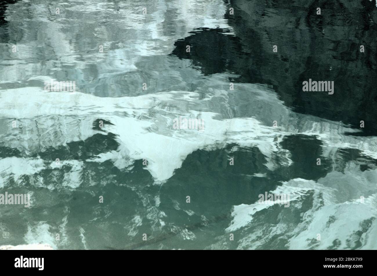 Abstract pattern of rock and ice reflected in water by the Eiger in ...