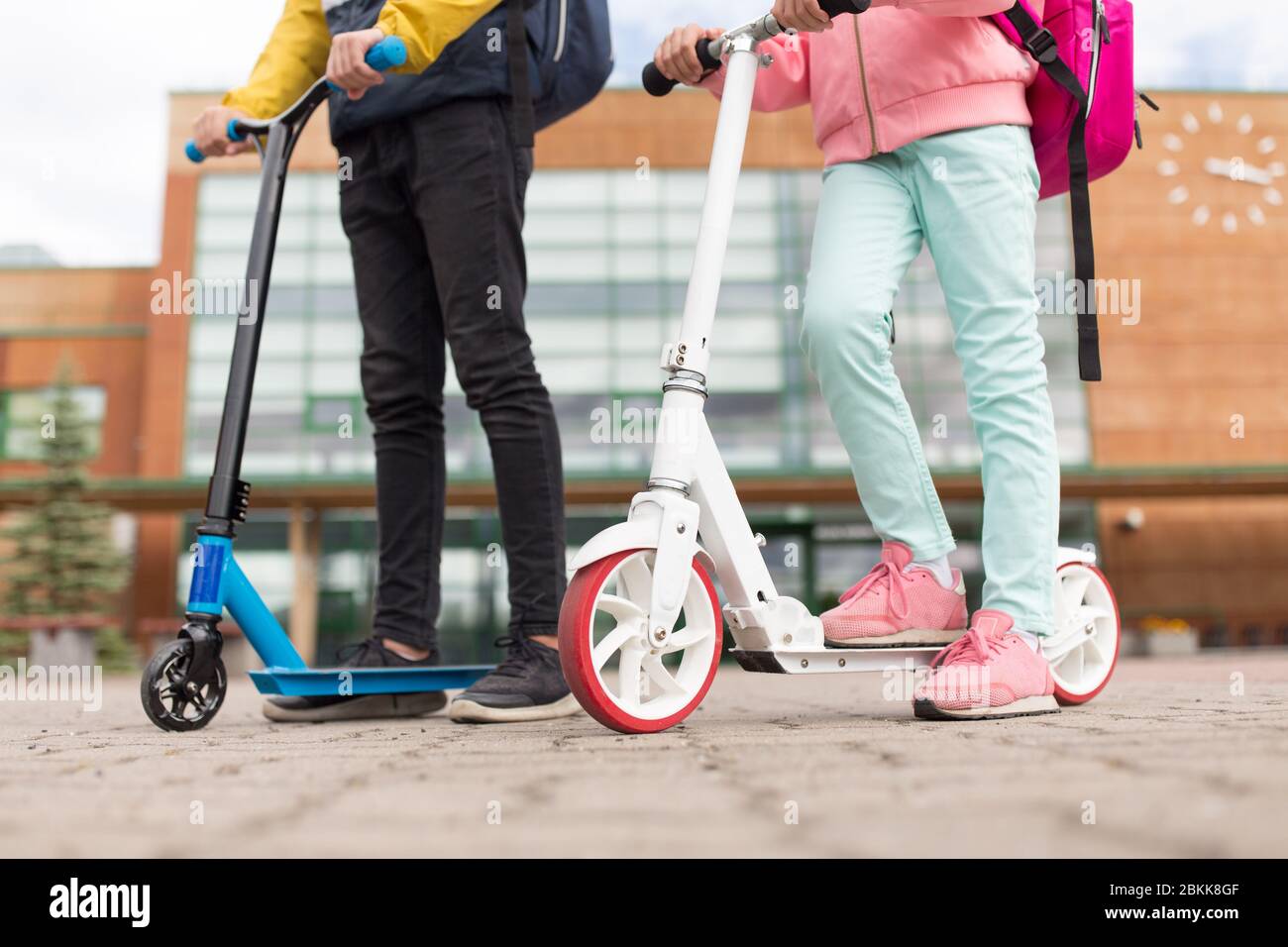 school children with backpacks and scooters Stock Photo - Alamy