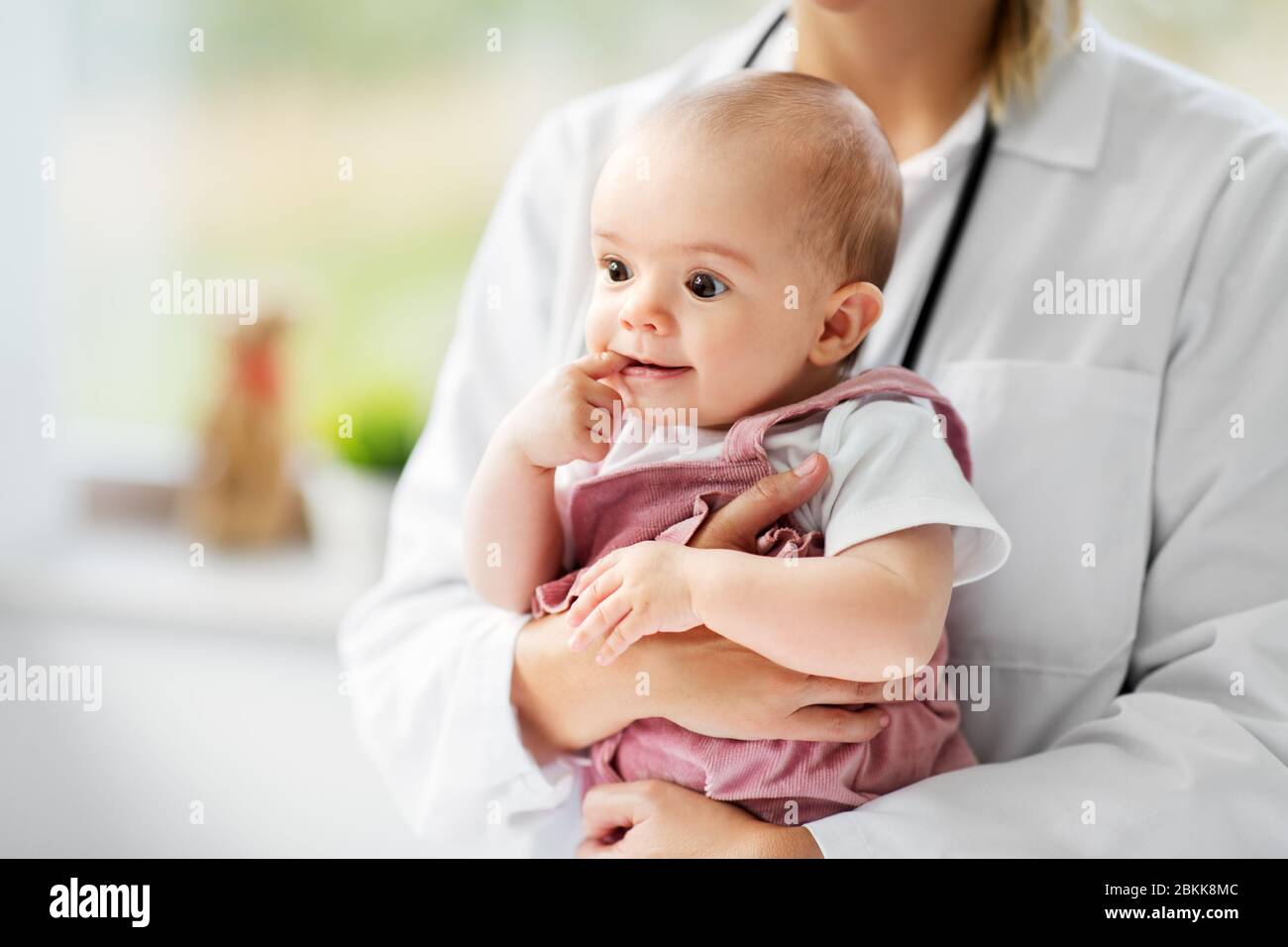 female pediatrician doctor with baby at clinic Stock Photo - Alamy