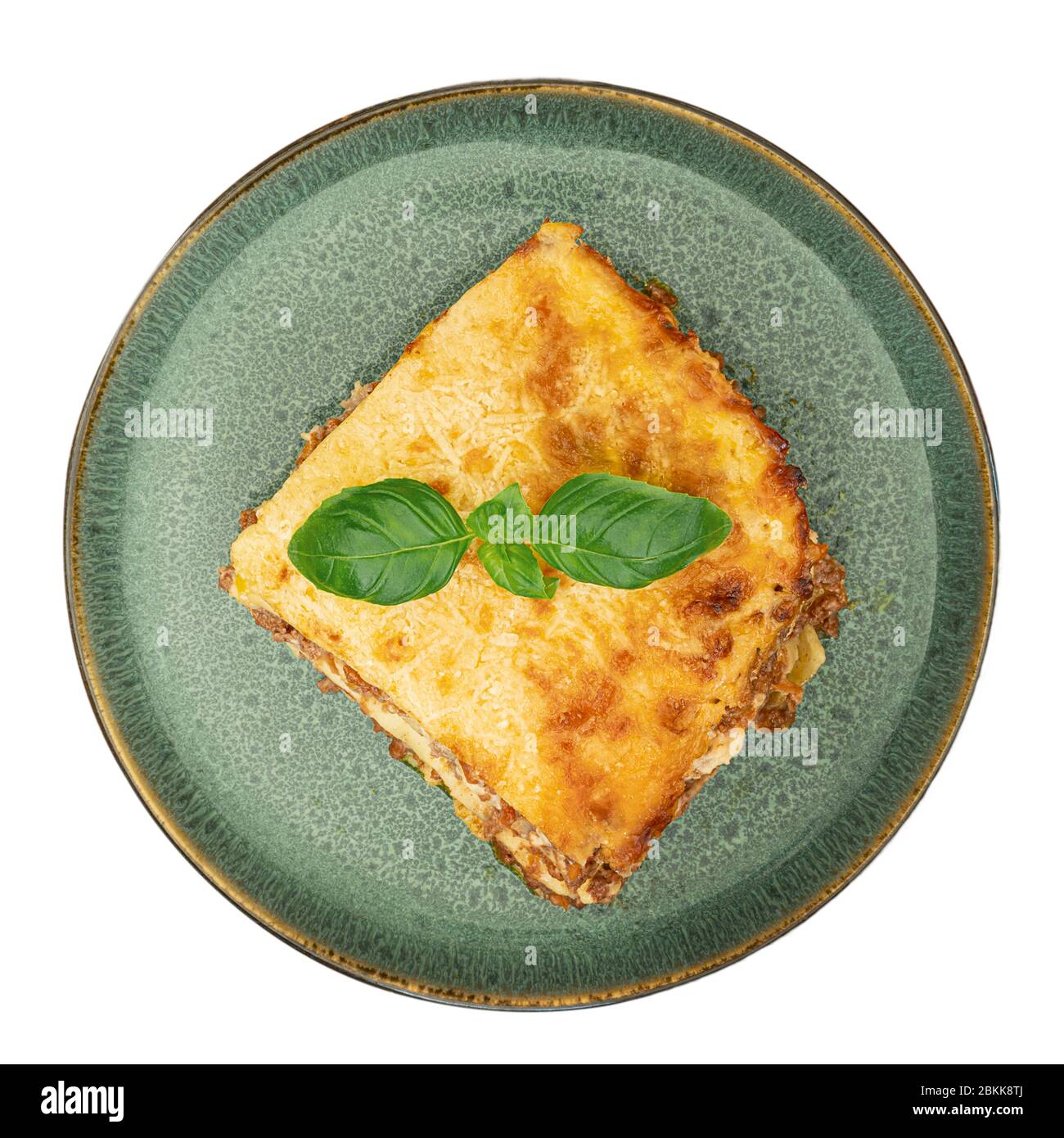 Classic Italian lasagna piece at plate on wooden table from above ...