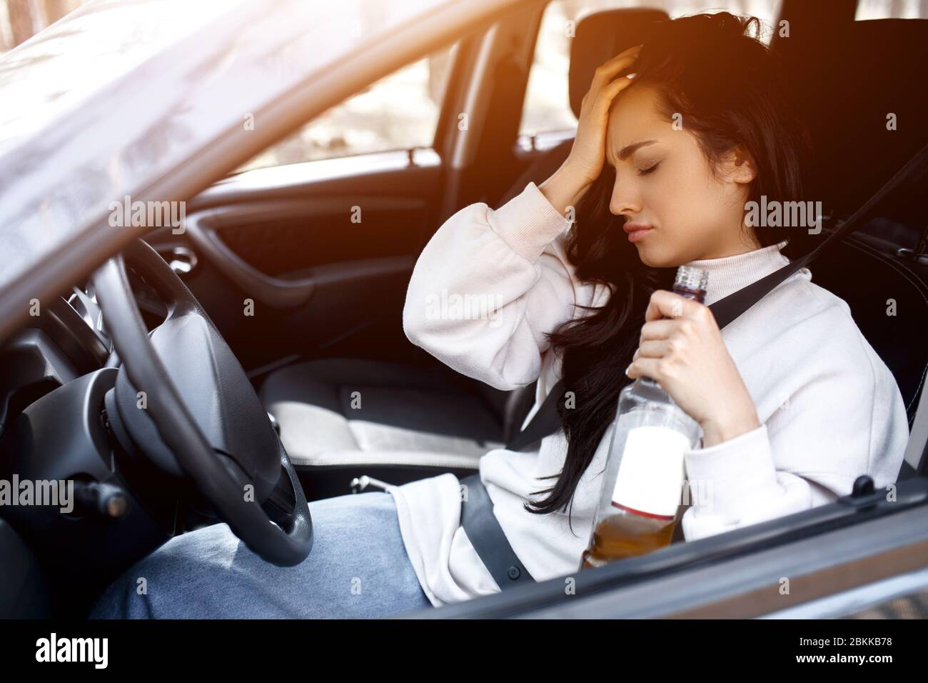 Drinking at the wheel. A drunk woman drives a car. Life threatening to ...