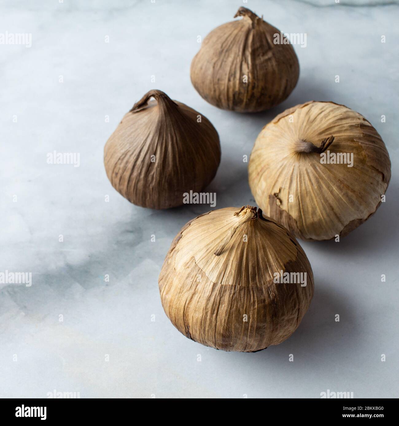 A group of black garlic, solo garlic bulb. A food ingredient, or ...